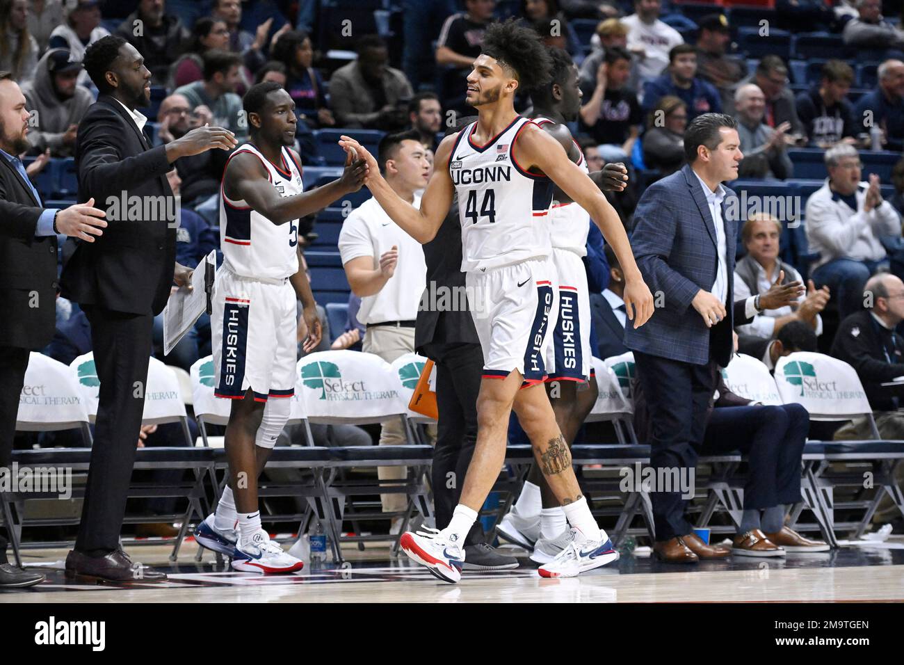 Connecticut's Andre Jackson Jr. (44) is greeted by teammates in the ...