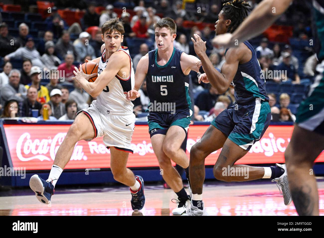 Connecticut's Apostolos Roumoglou (33) of Greece is guarded by UNC ...