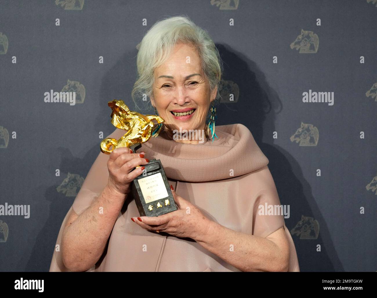 Taiwanese actress Kagaw Piling holds her award for Best Supporting ...