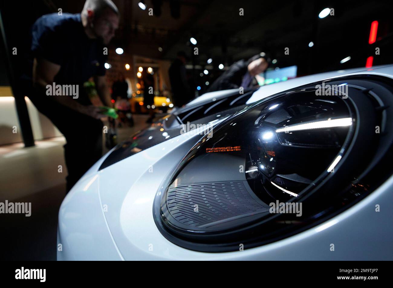 Sports car detailer Tony Gillis cleans fingerprints off a Porsche 911 GT3 RS shown at the ...
