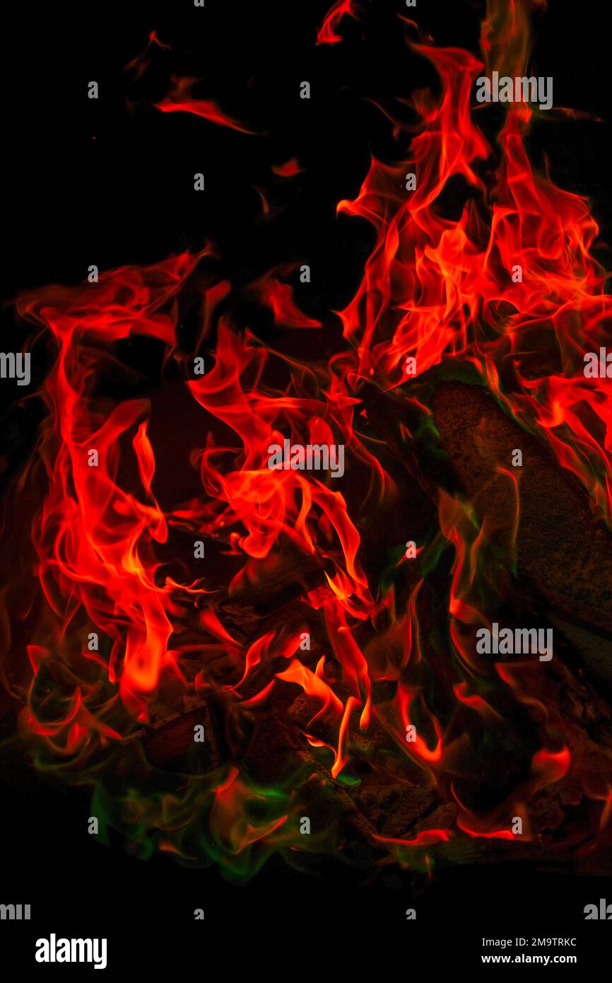 Variegated flames and colorful sparks.Multicolored flame.Firewood ...