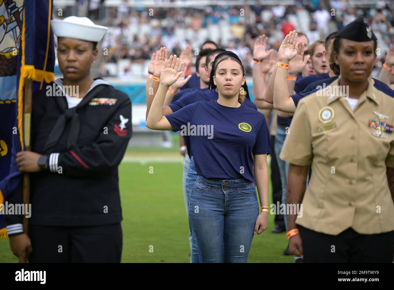 U.S. Navy recruits are sworn in during halftime on Salute to Service ...