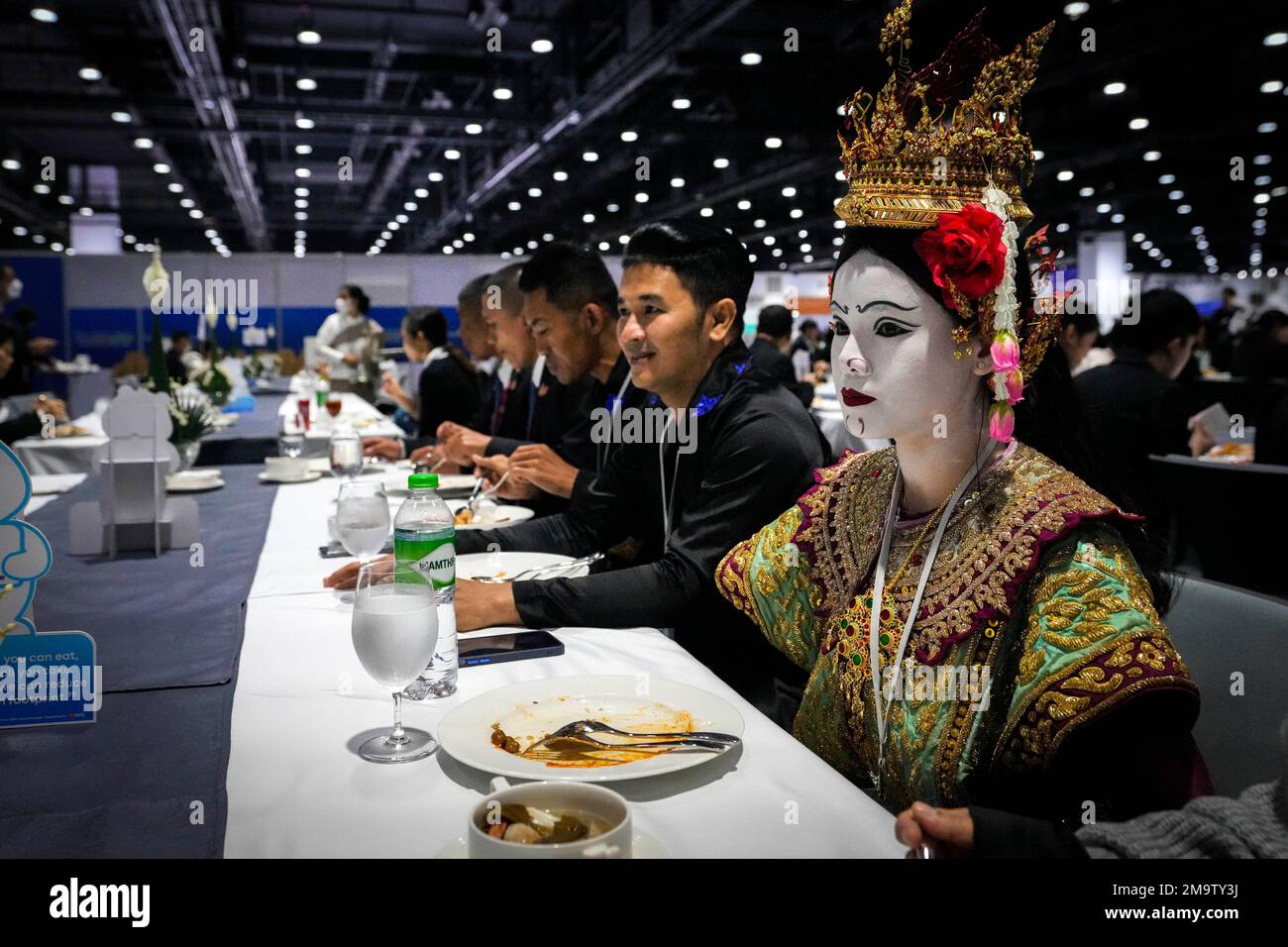 A Thai traditional dancer in costume finishes her lunch at the Asia ...