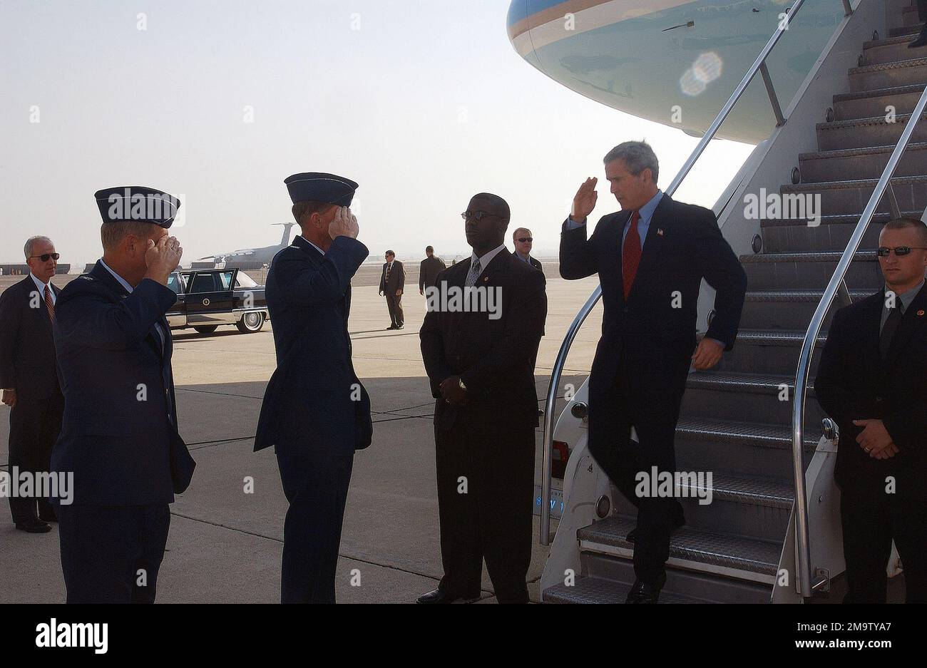 US President George W. Bush salutes US Air Force (USAF) Colonel (COL ...