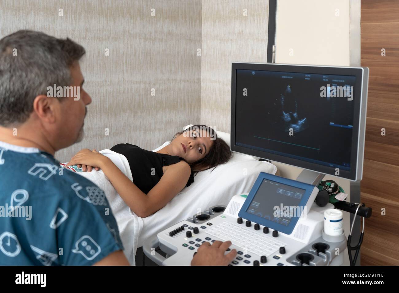 Doctor Looking At Ultrasound Images Doctor Examining Ultrasound Of