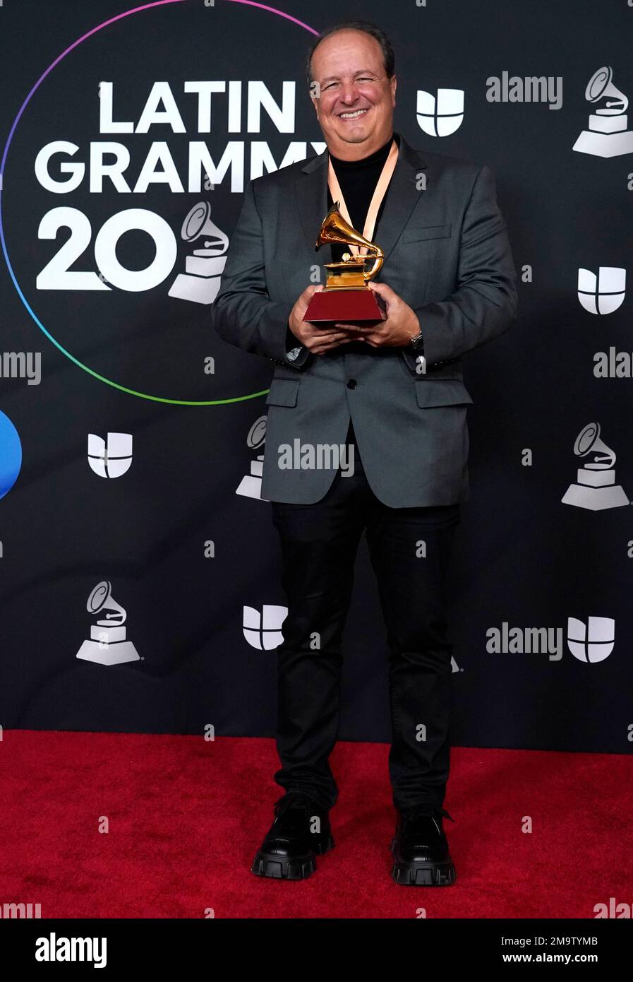 Julio Reyes Copello poses in the press room with the award for producer of the year at the 23rd ...