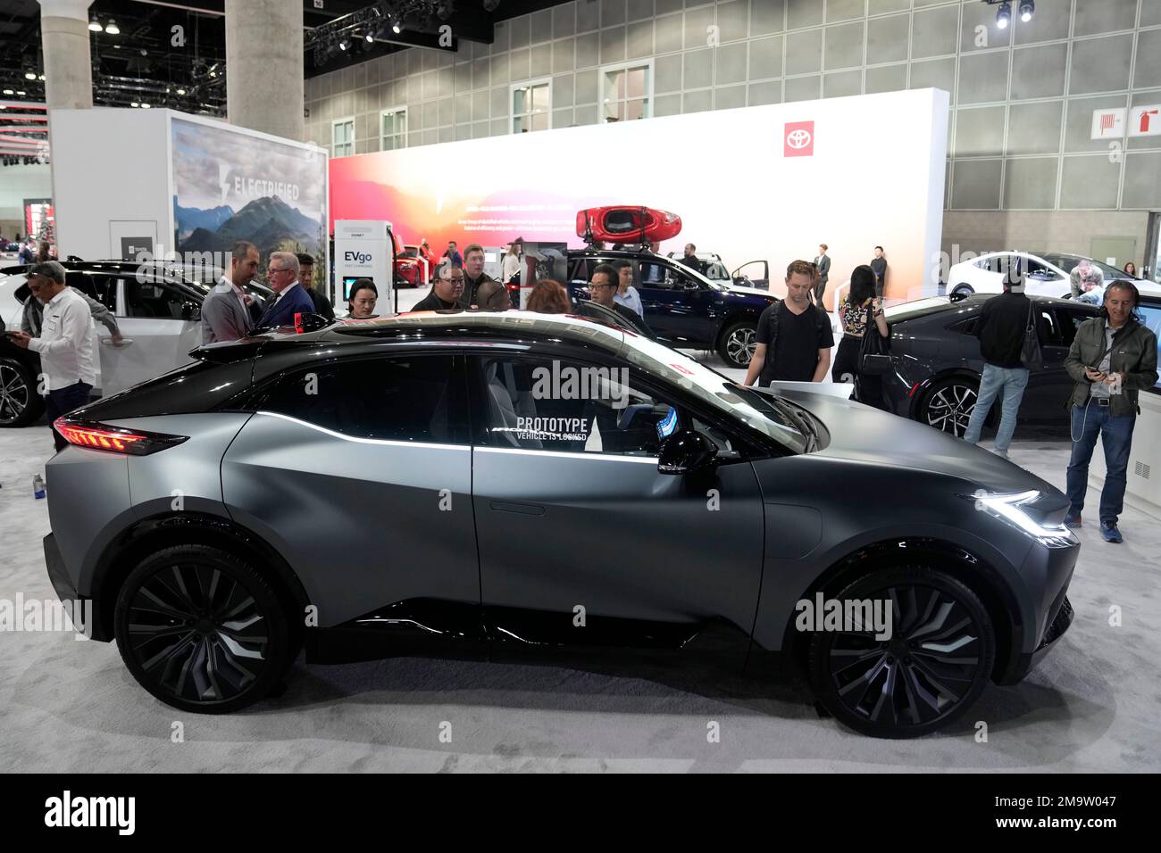 People look at a prototype Toyota bZ Compact SUV Concept displayed at ...