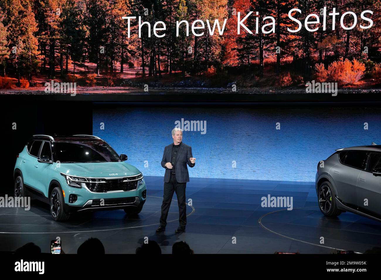 Russell Wager, Kia America vice president of marketing, speaks next to ...