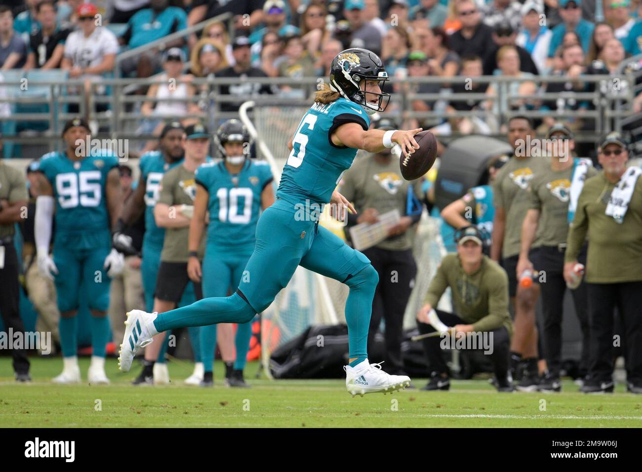 Jacksonville Jaguars quarterback Trevor Lawrence (16) scrambles for yardage during the first ...