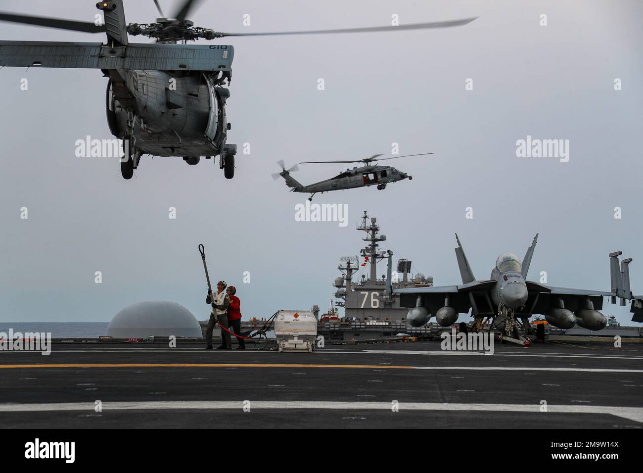 PHILIPPINE SEA (May 20, 2022) Rear Adm. J.T. Anderson, left, commander, Carrier Strike Group ...
