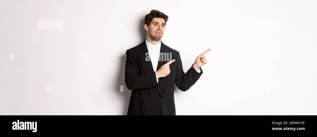 Image of upset and disappointed handsome guy in formal suit, pointing ...