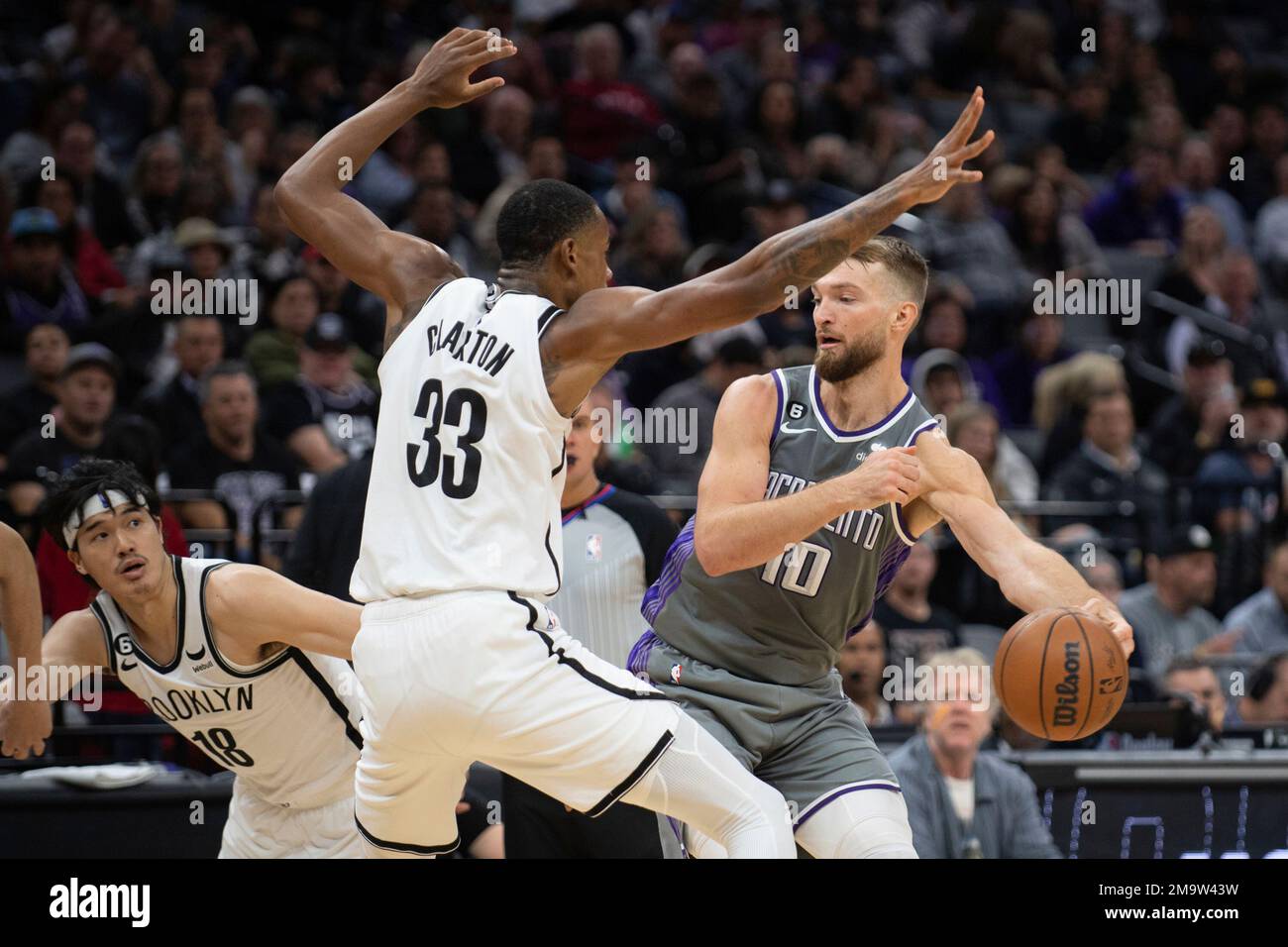 Sacramento Kings forward Domantas Sabonis (10) makes a pass around Brooklyn Nets forward Nic ...