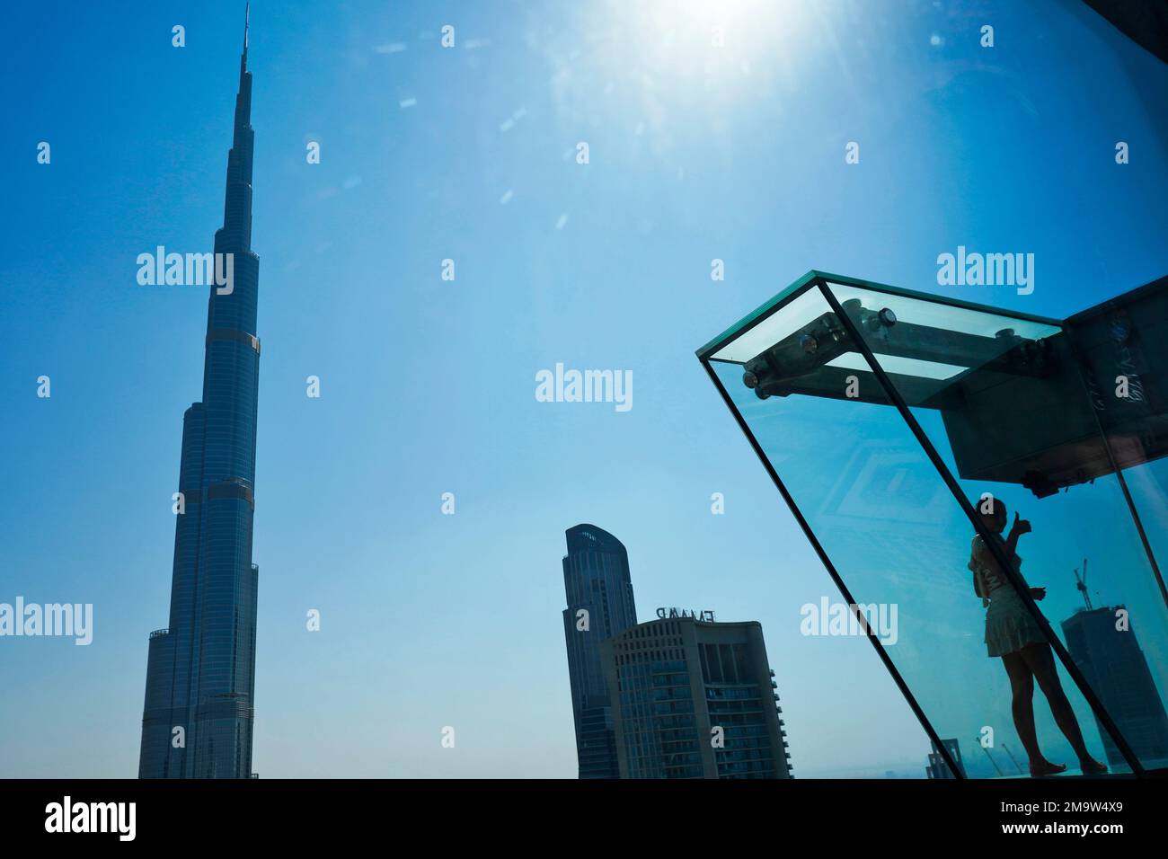 A woman poses for a photograph with the Burj Khalifa, the world's ...
