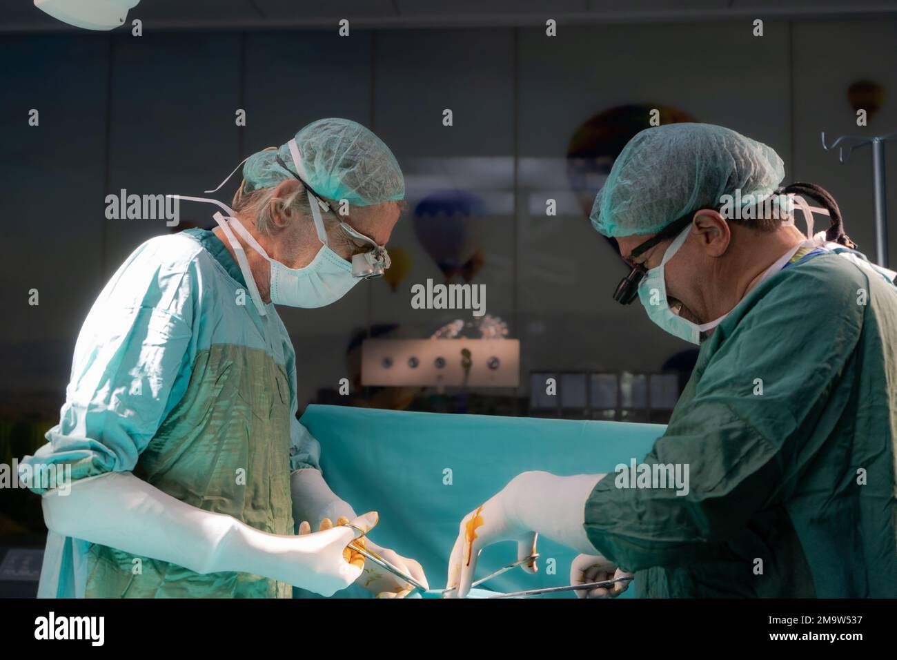 Open heart surgery doctor perform open heart surgery. Doctors in green uniforms are in the ...