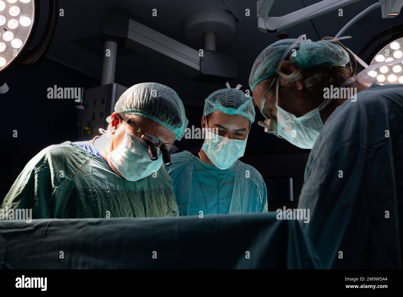 Open heart surgery doctor perform open heart surgery. Doctors in green ...
