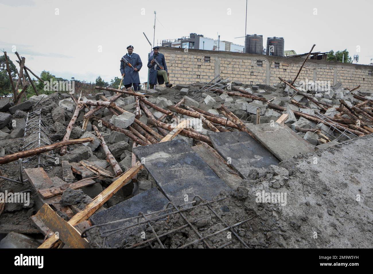 Kenyan police attend the scene of a building collapse in Ruaka, on the ...