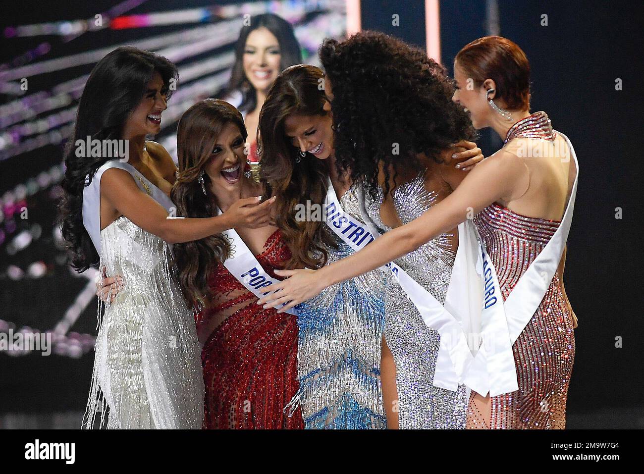 The five final contestants embrace during the annual Miss Venezuela ...