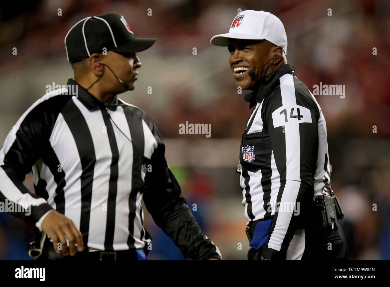 Referee Shawn Smith (14) and down judge Patrick Holt (106) converse ...