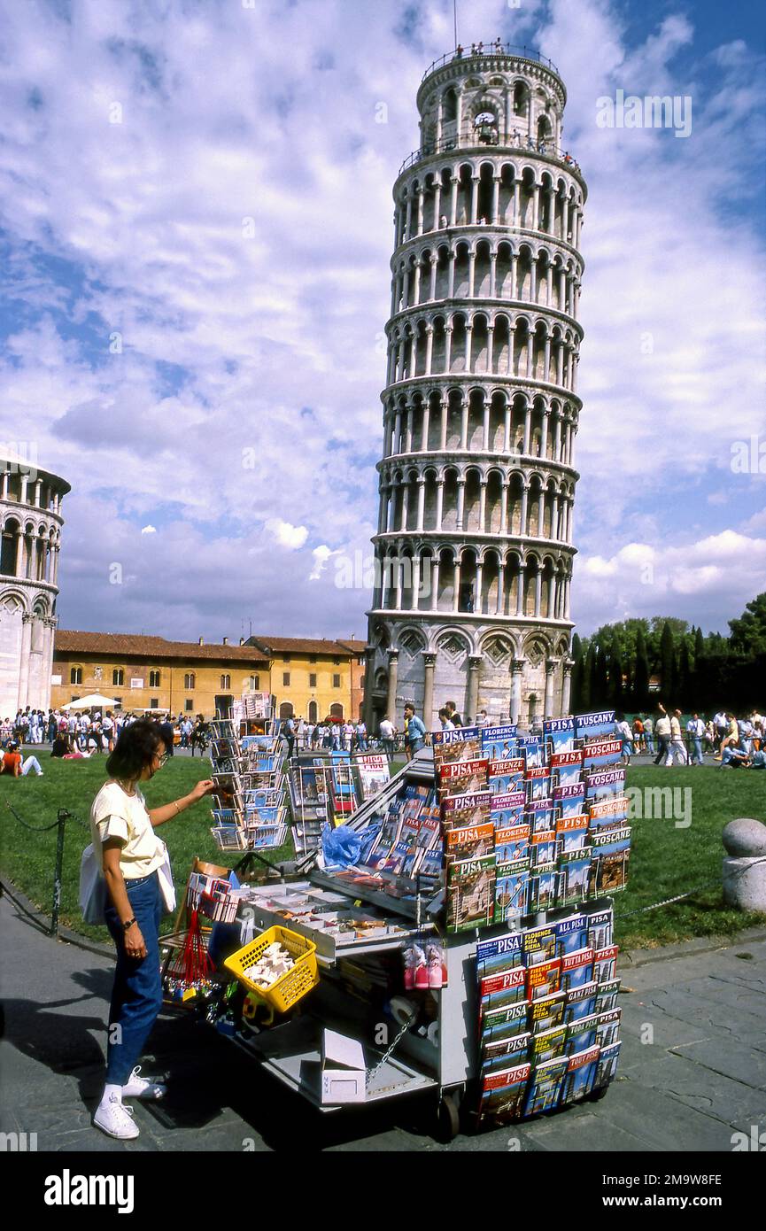 Woman looking at souvenirs in front of the Leaning Tower of Pisa in ...