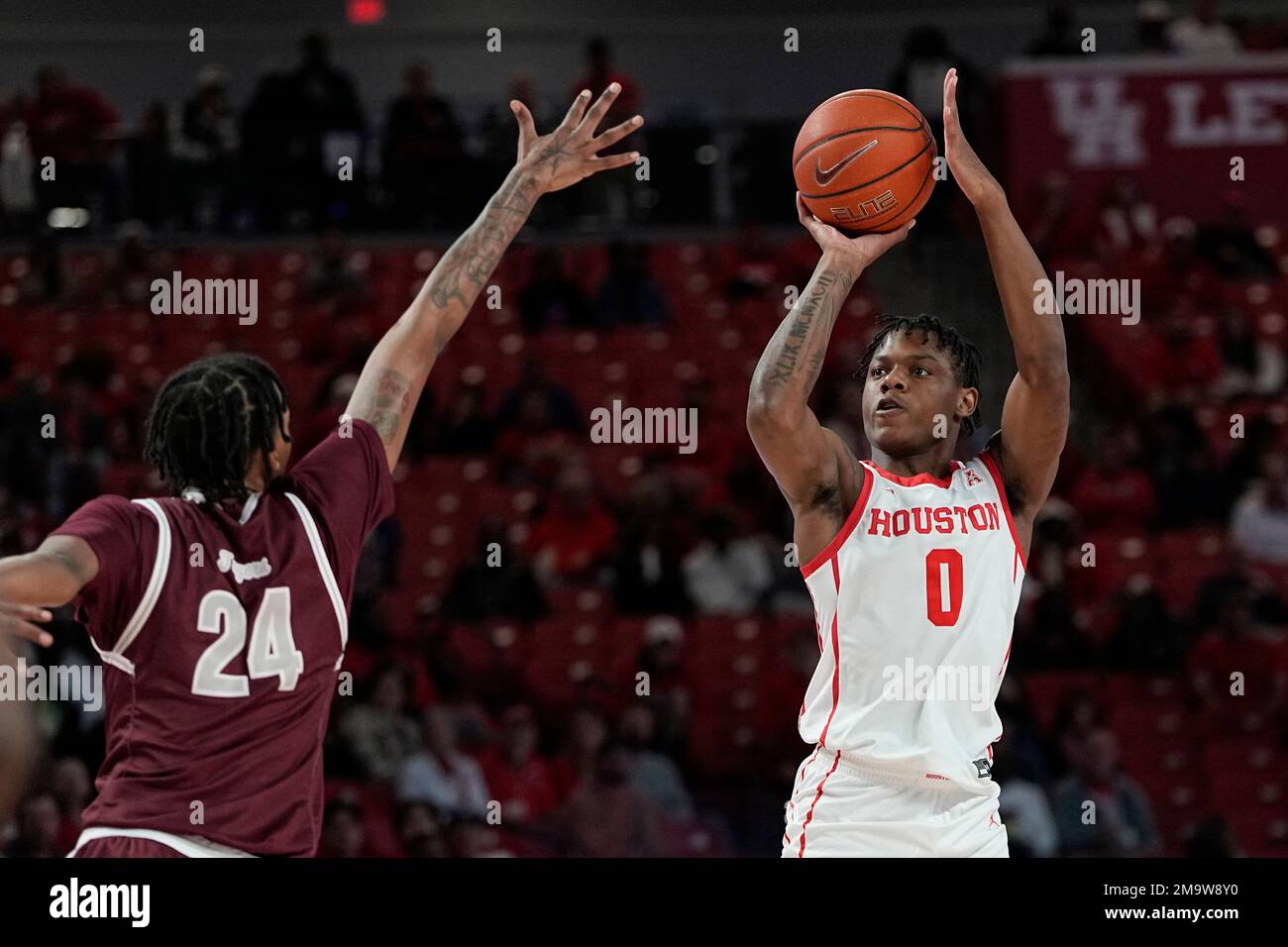 Houston's Marcus Sasser (0) shoots as Texas Southern's John Walker (24 ...