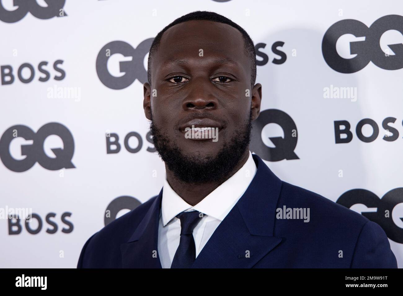 Stormzy poses for photographers upon arrival at the GQ Men of the Year ...