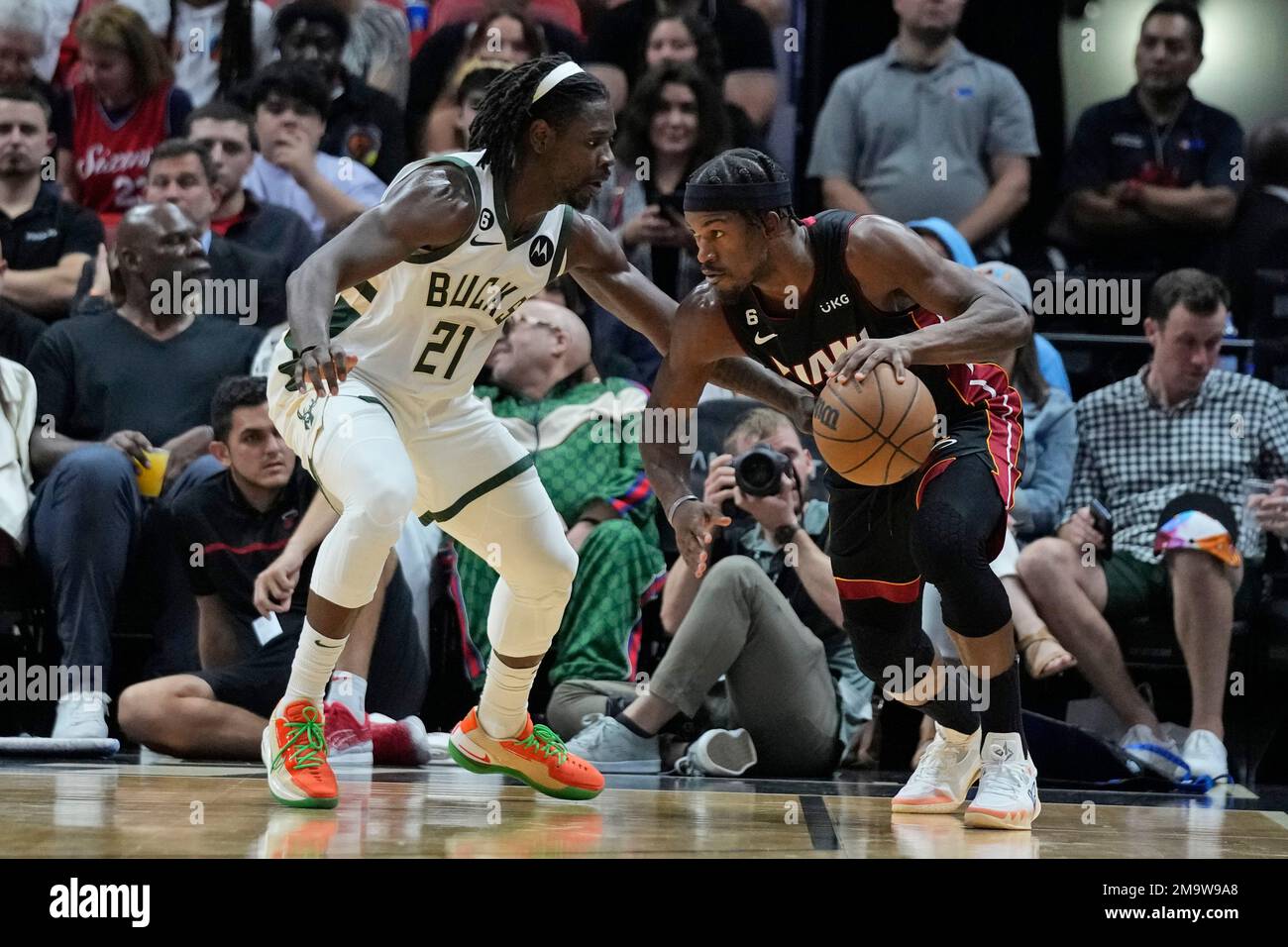Miami Heat forward Jimmy Butler, right, drives to the basket against ...