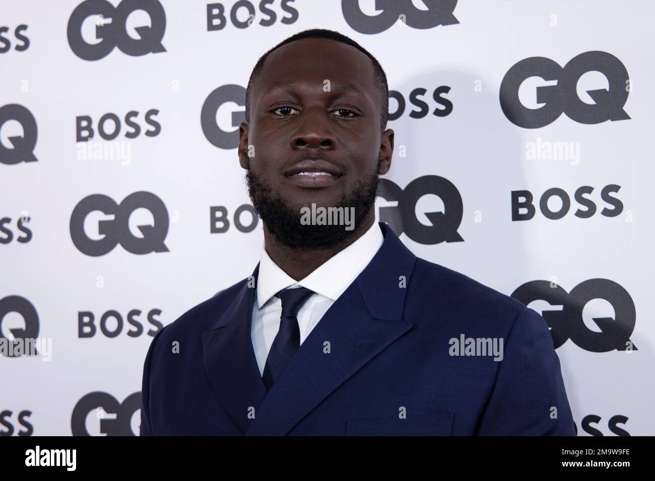 Stormzy poses for photographers upon arrival at the GQ Men of the Year ...