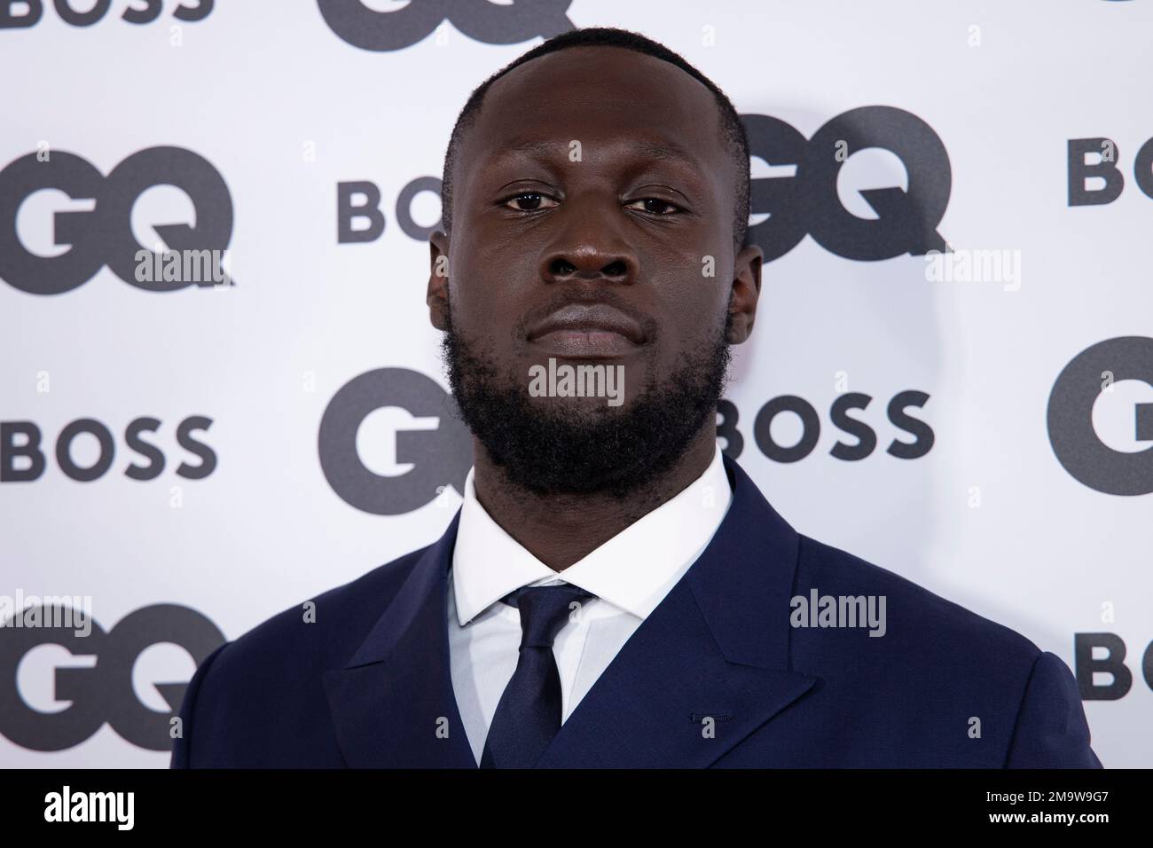 Stormzy poses for photographers upon arrival at the GQ Men of the Year ...