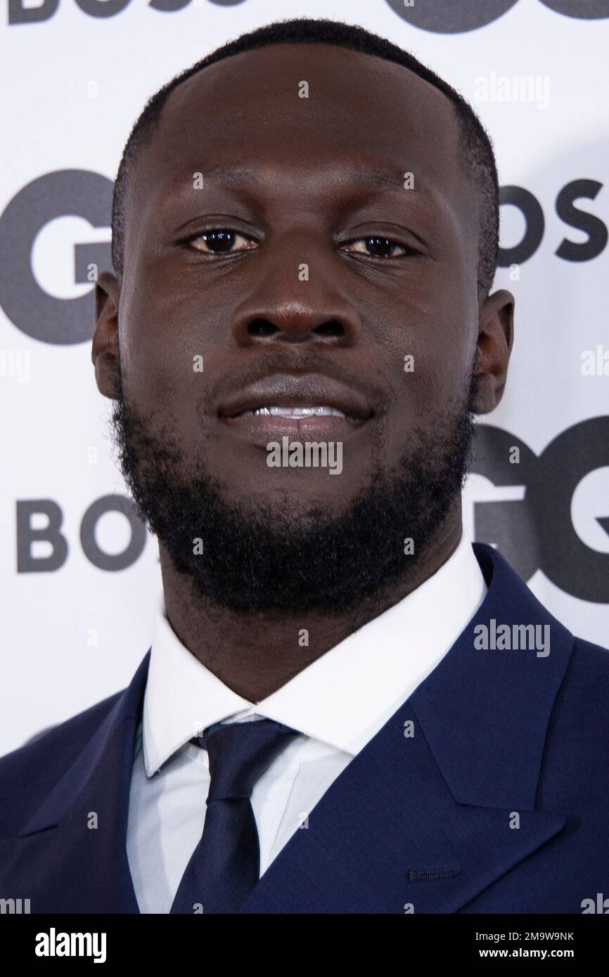 Stormzy poses for photographers upon arrival at the GQ Men of the Year ...