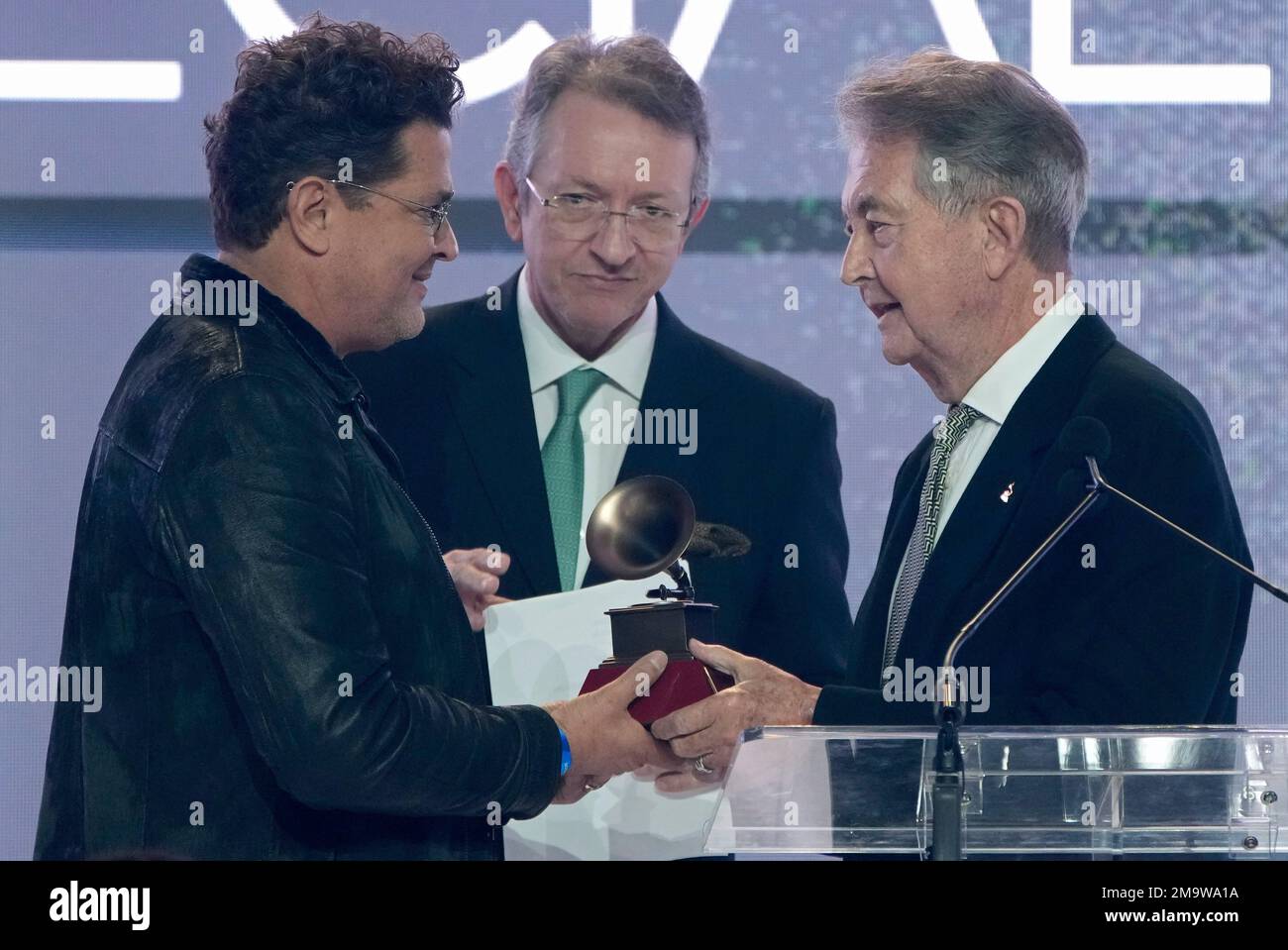 Manolo Diaz, right, receives the trustees award from Carlos Vives, left ...
