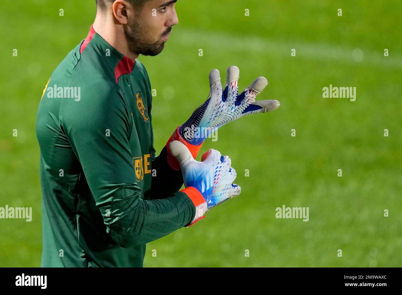 Portugal goalkeeper Diogo Costa puts on his gloves at the start of a ...