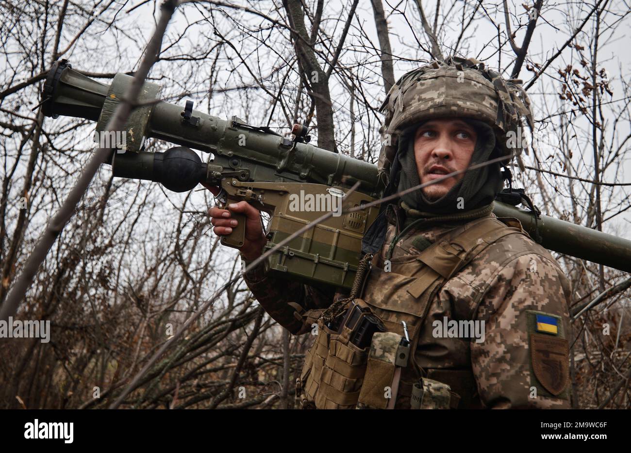 An Ukrainian soldier stands holding an anti-aircraft rocket launcher on ...