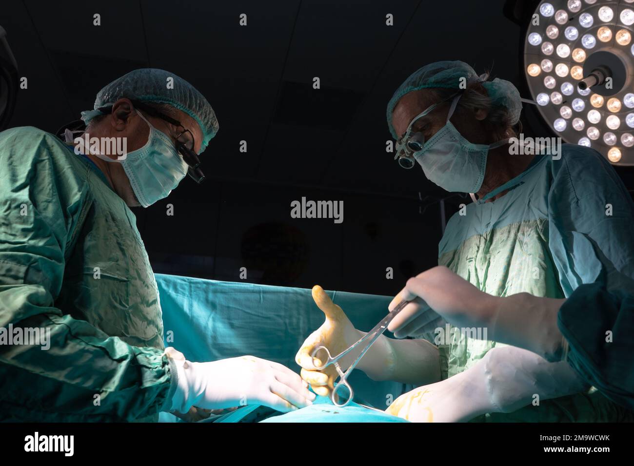 Open heart surgery doctor perform open heart surgery. Doctors in green ...