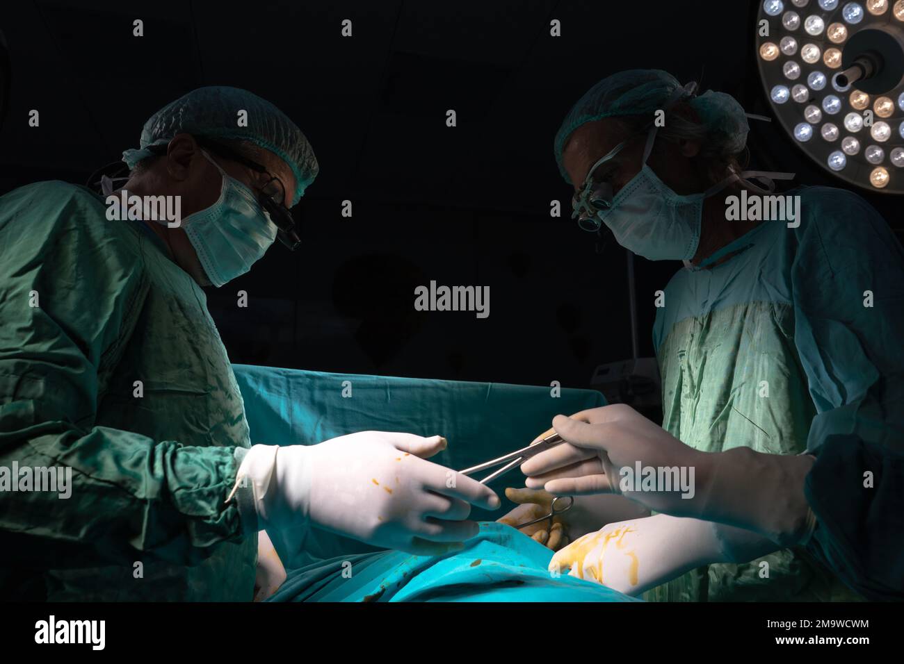 Open heart surgery doctor perform open heart surgery. Doctors in green ...