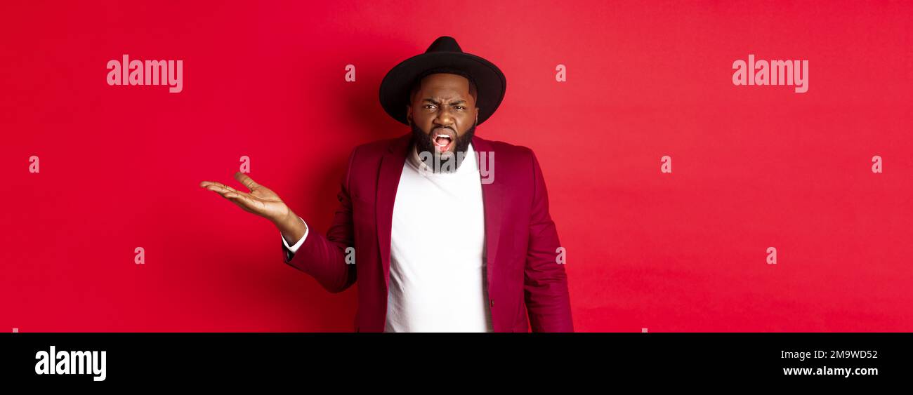 Angry and confused Black man arguing, shouting at camera and raising ...