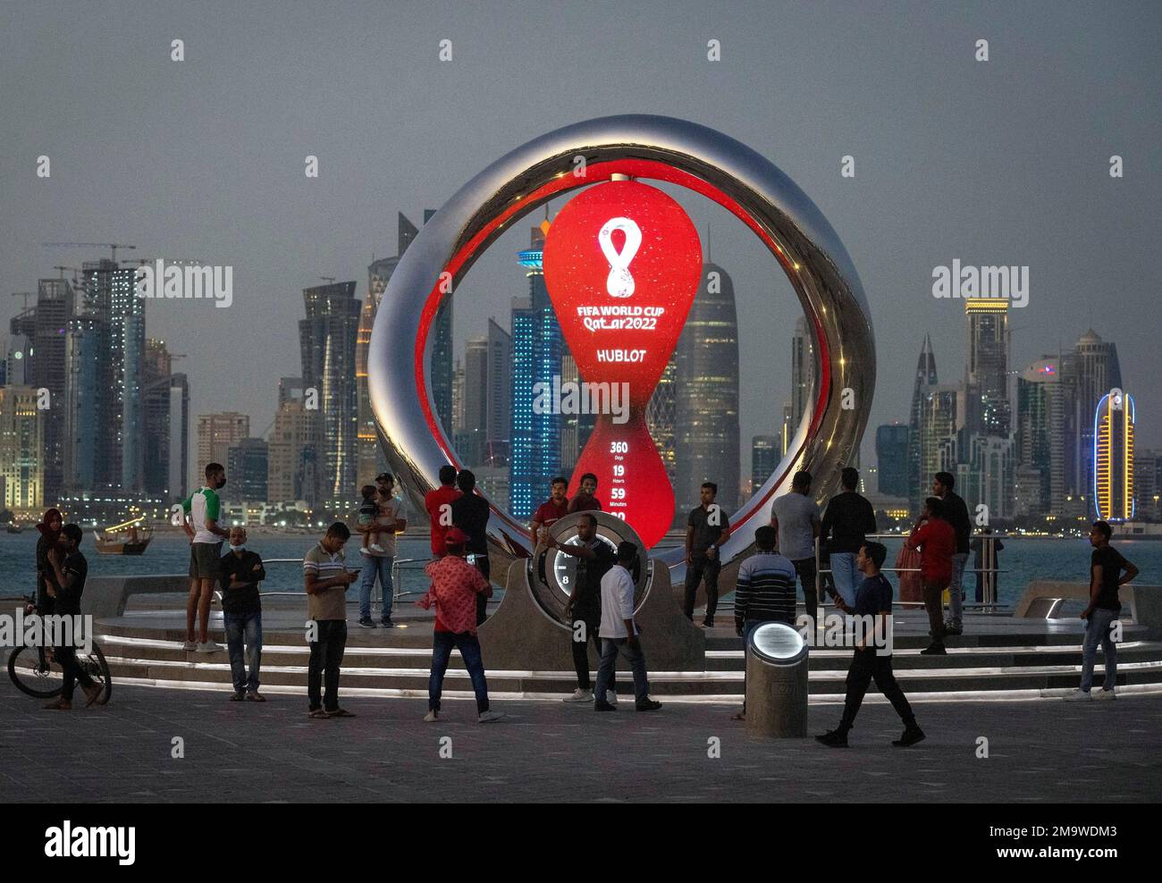 FILE - People gather around the official countdown clock showing ...