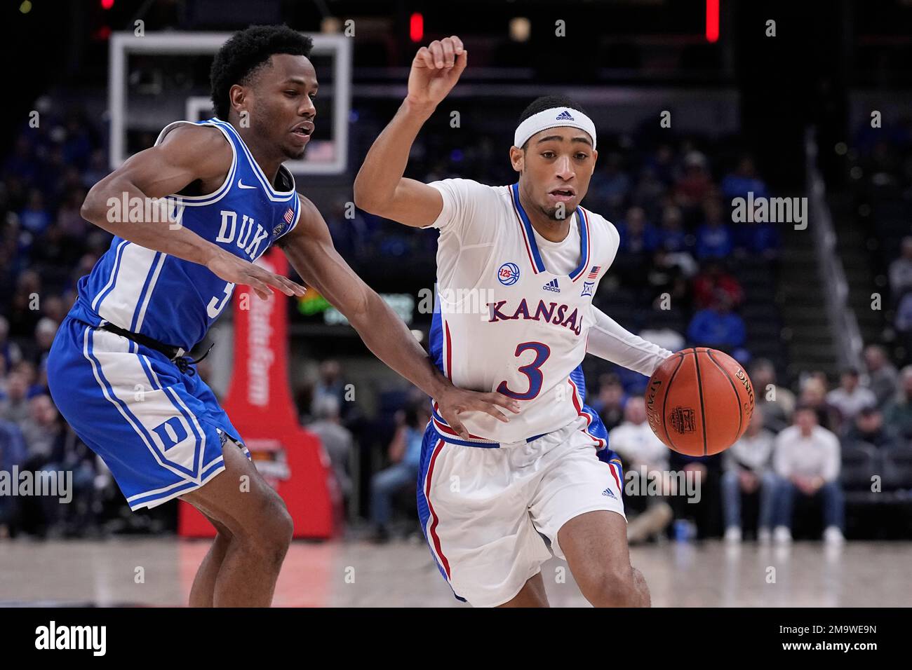 Kansas guard Dajuan Harris Jr., right, drives around Duke guard Jeremy ...