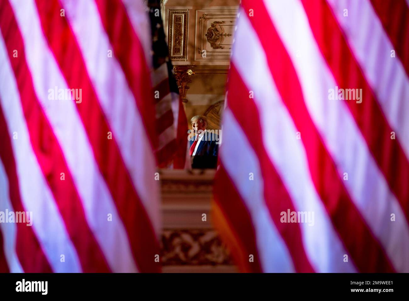 Former President Donald Trump, seen in reflection, announces he is ...