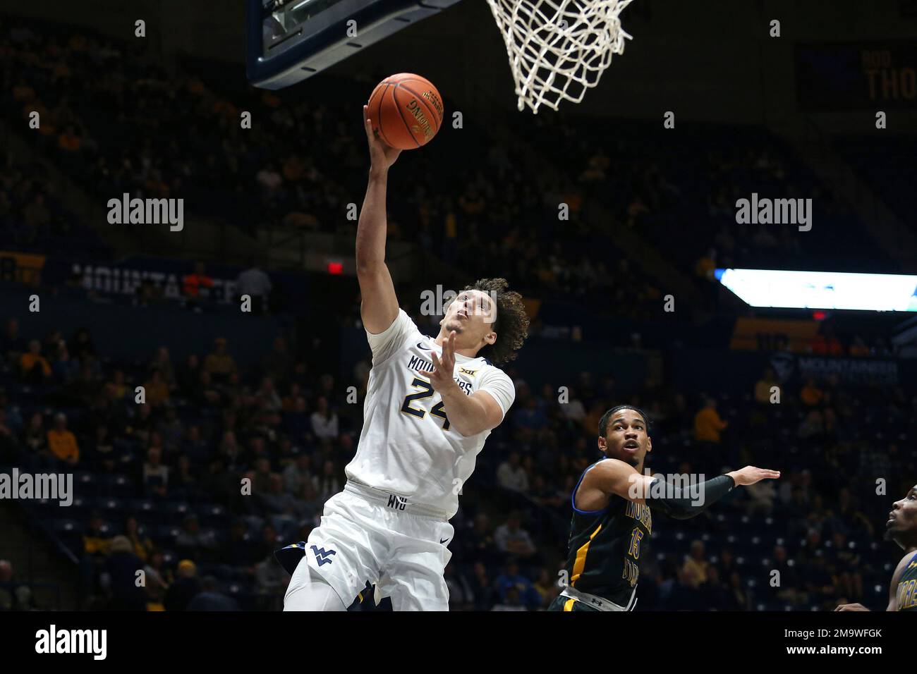 West Virginia forward Patrick Suemnick (24) shoots while defended by ...