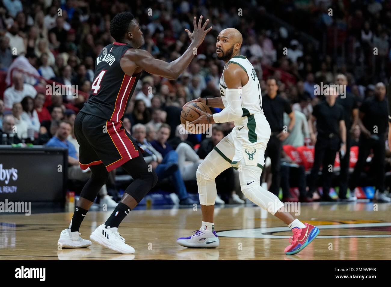 Milwaukee Bucks guard Jevon Carter, right, looks for an opening past ...