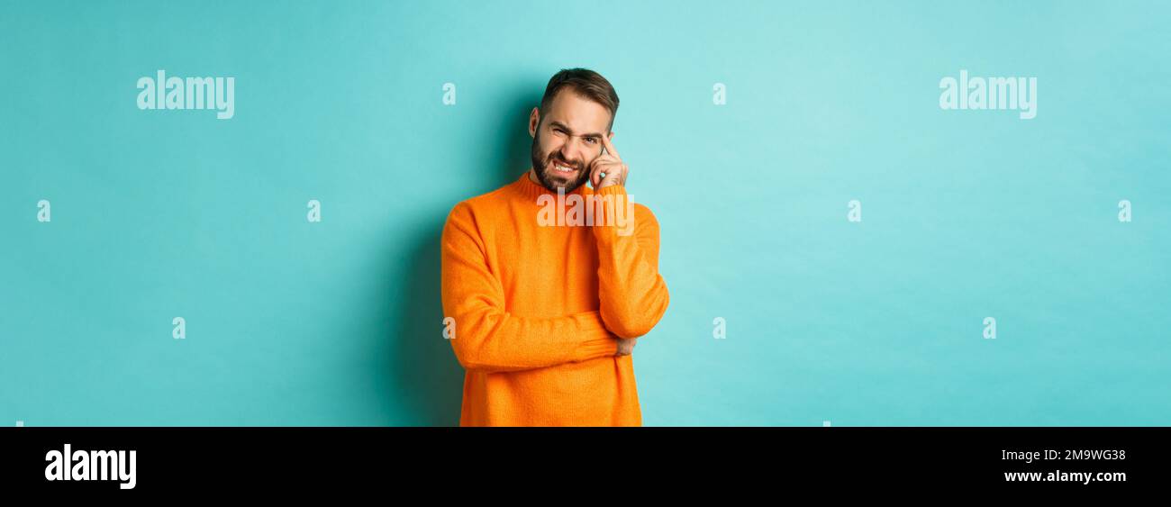 Man with beard, grimacing and cringe from something embarrassing ...