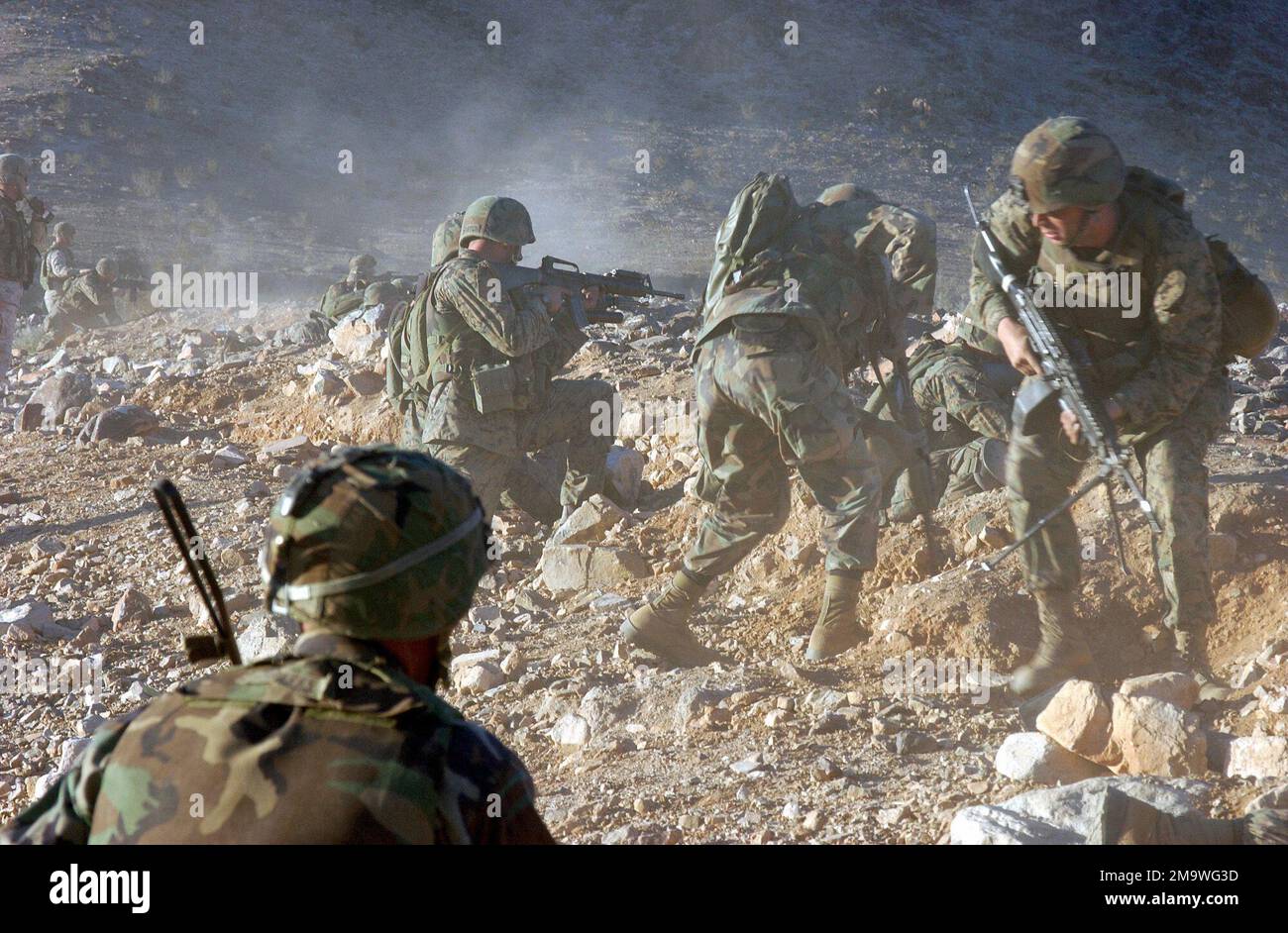 US Marine Corps (USMC) Marines armed with 5.56mm M16A2 rifles and M249 ...