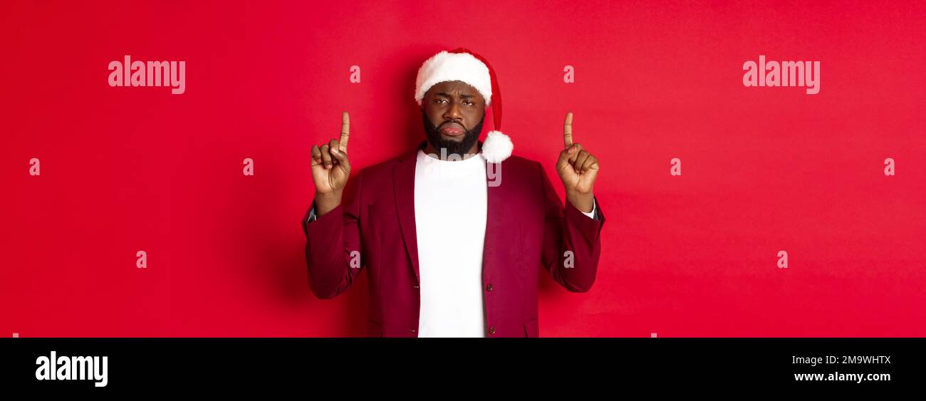 Christmas, party and holidays concept. Miserable and sad african ...