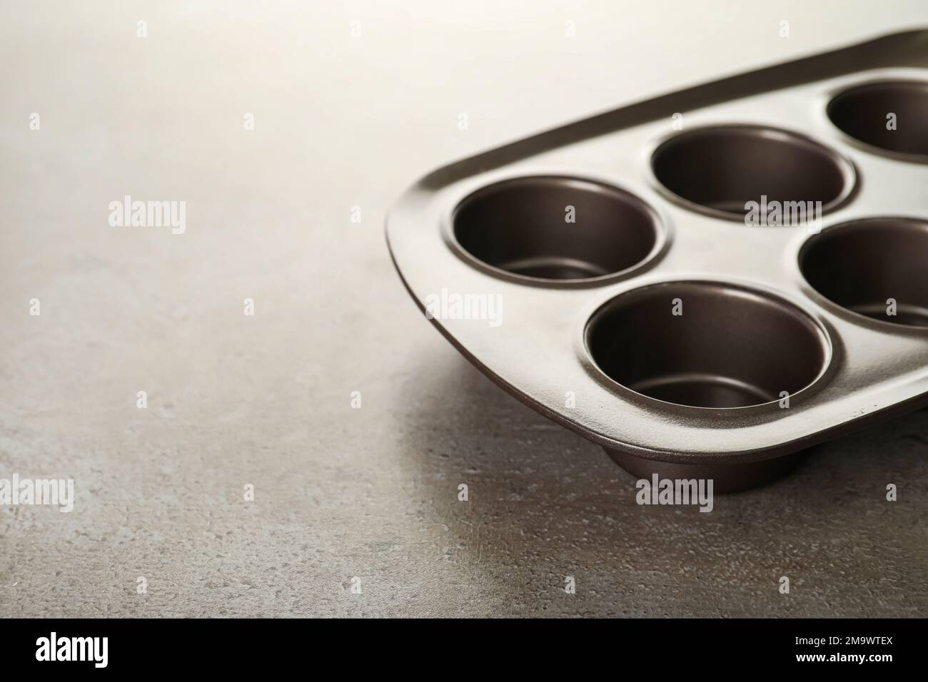 Muffin tray on grunge background, closeup Stock Photo - Alamy