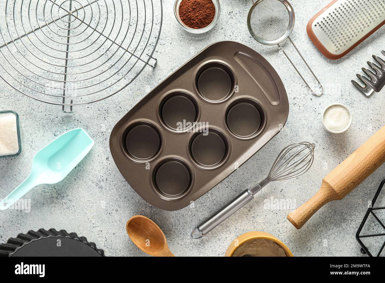 Set of kitchen utensils with muffin tray, cocoa powder and sugar on ...