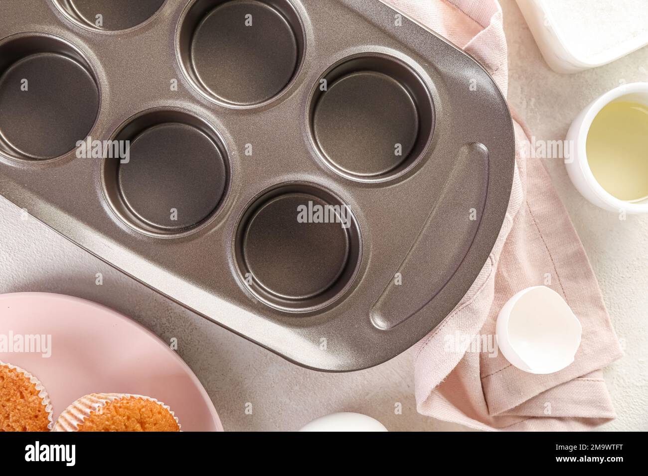 Muffin tray on light table, closeup Stock Photo - Alamy