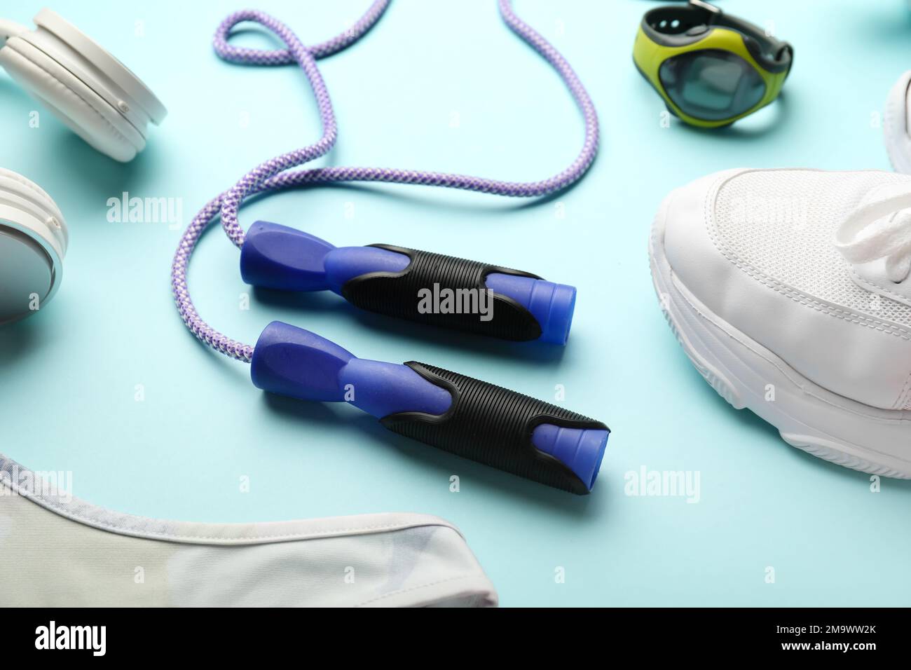 Skipping rope on blue background, closeup Stock Photo - Alamy