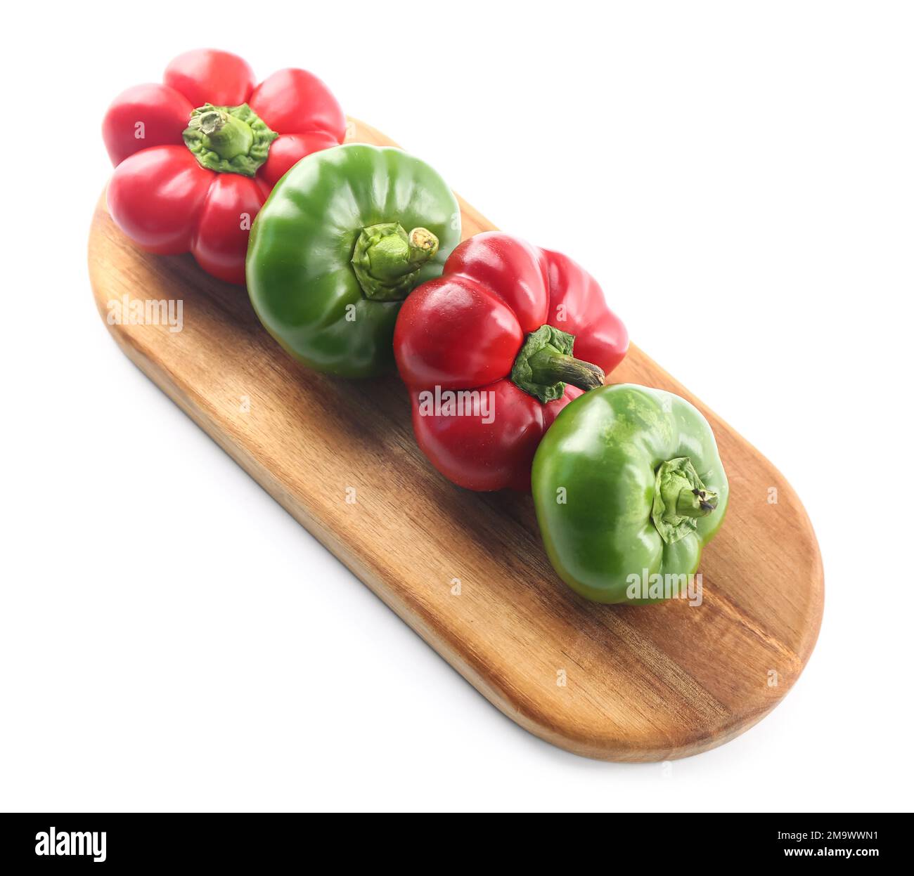 Wooden board with fresh bell peppers on white background Stock Photo ...