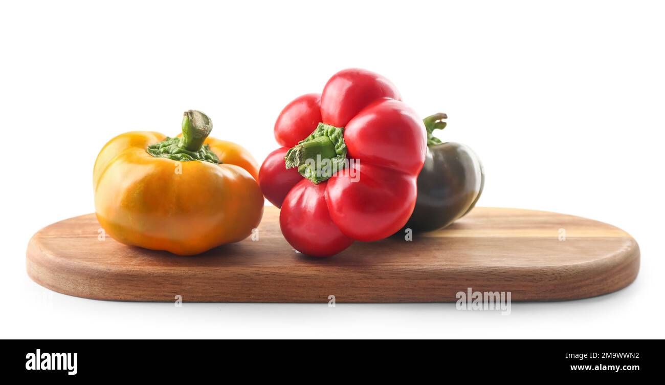 Wooden board with fresh bell peppers isolated on white background Stock ...