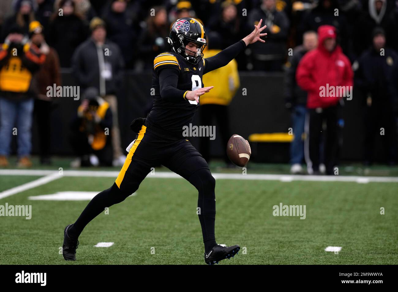 Iowa punter Tory Taylor punts during the first half of an NCAA college ...